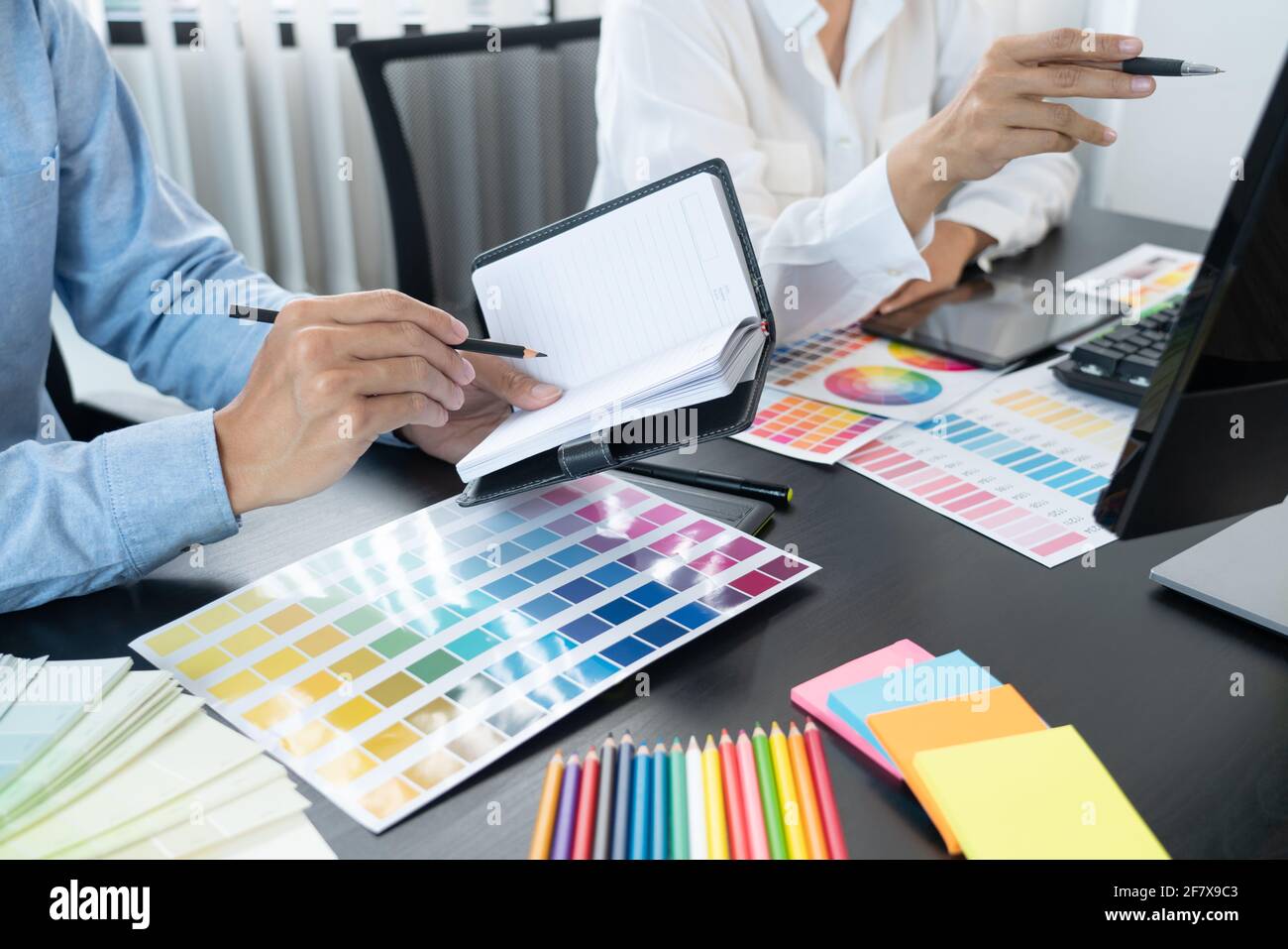 graphic designer team working on web design using color swatches ...