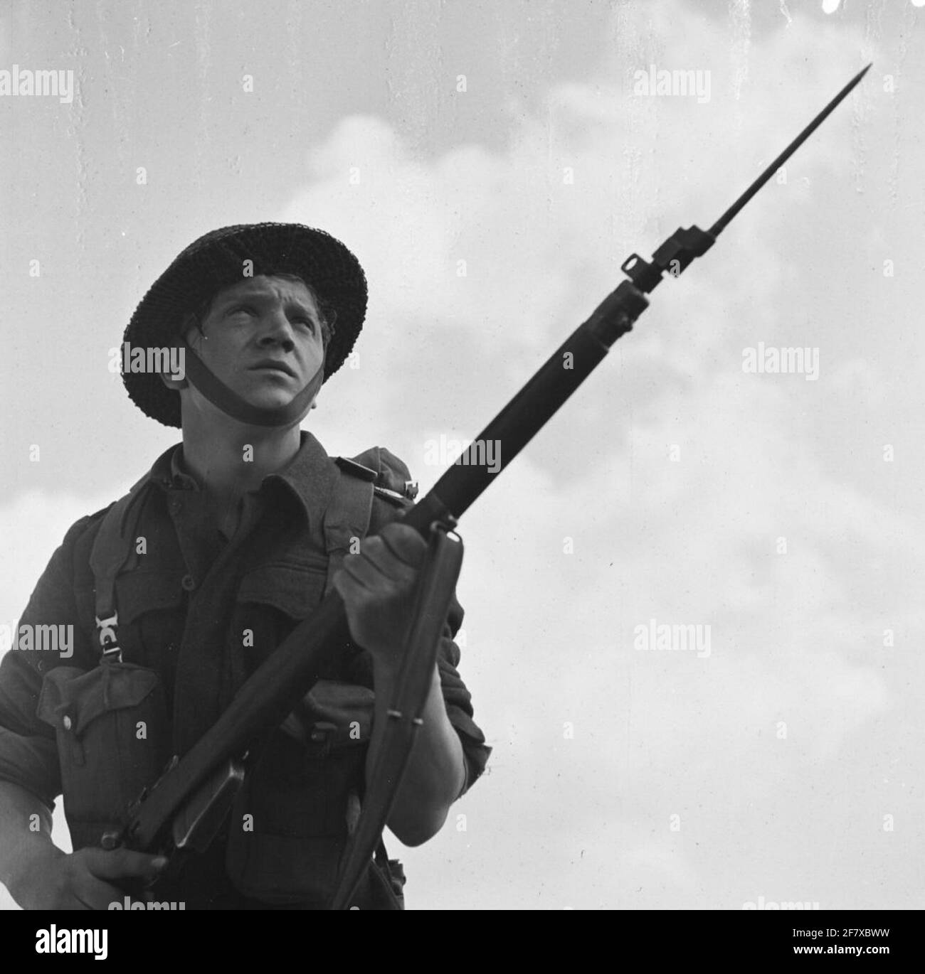 An infantryman with combat packaging and his Lee Enfield rifle with ...
