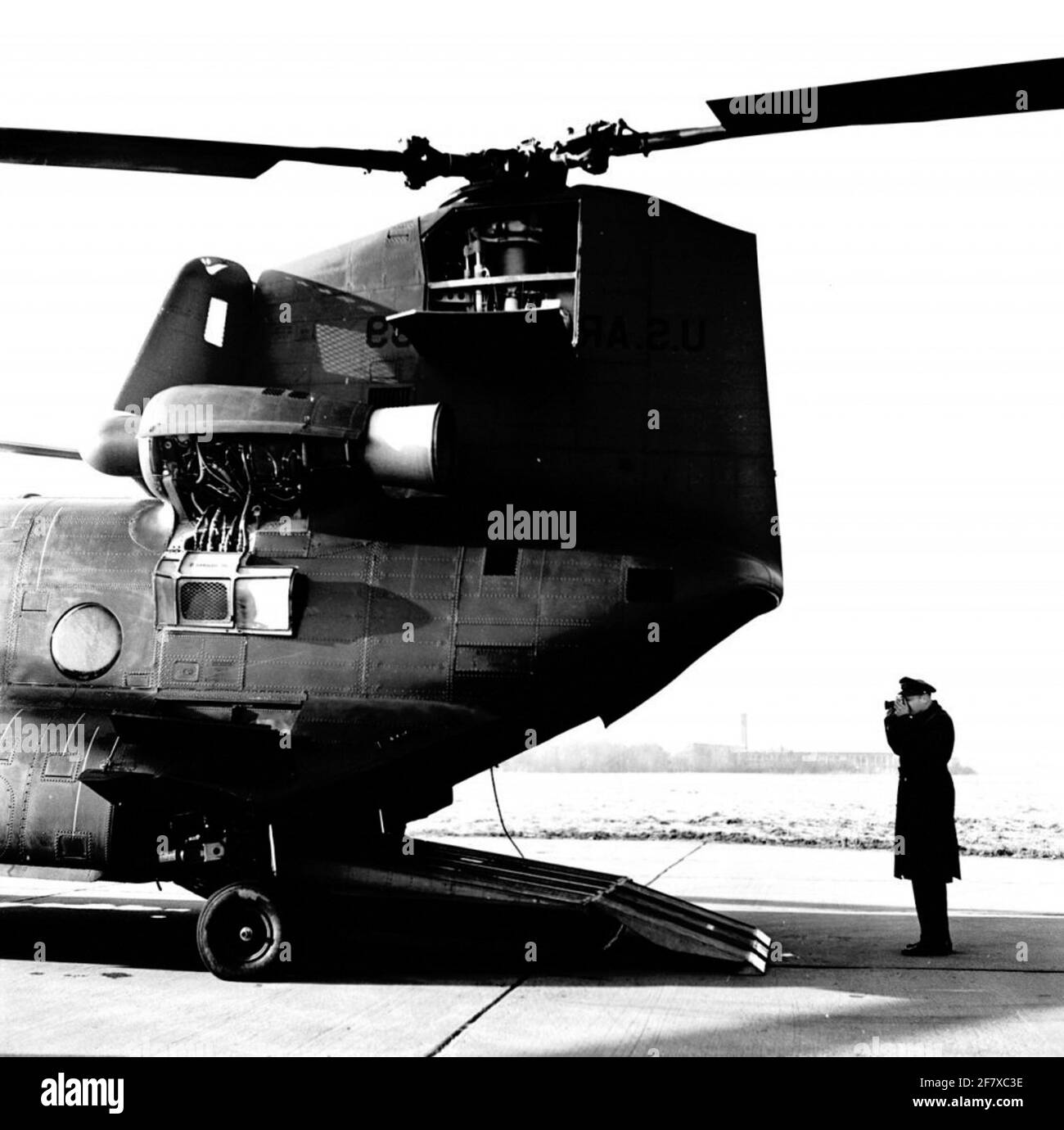 A Boeing Chinook stands with opened tailgate on the platform. A soldier ...