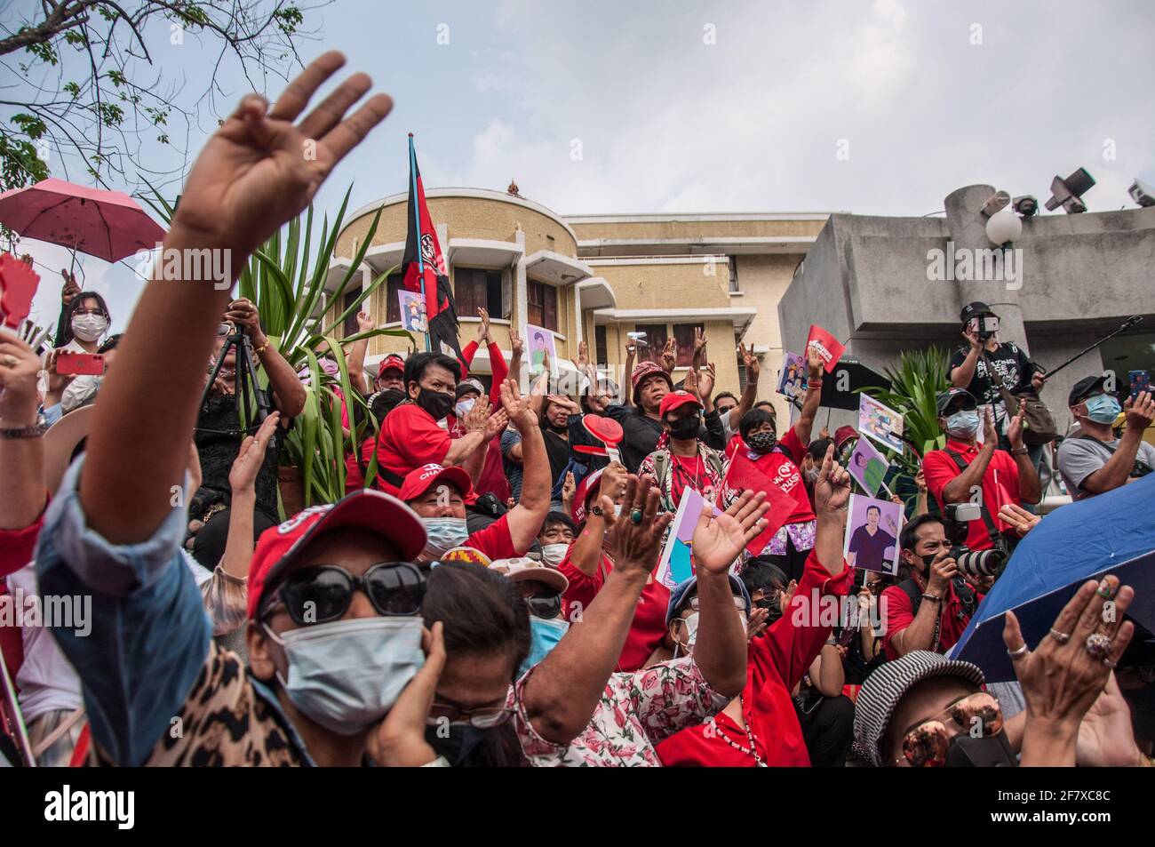 A protester makes three finger salute during the anniversary. Former ...