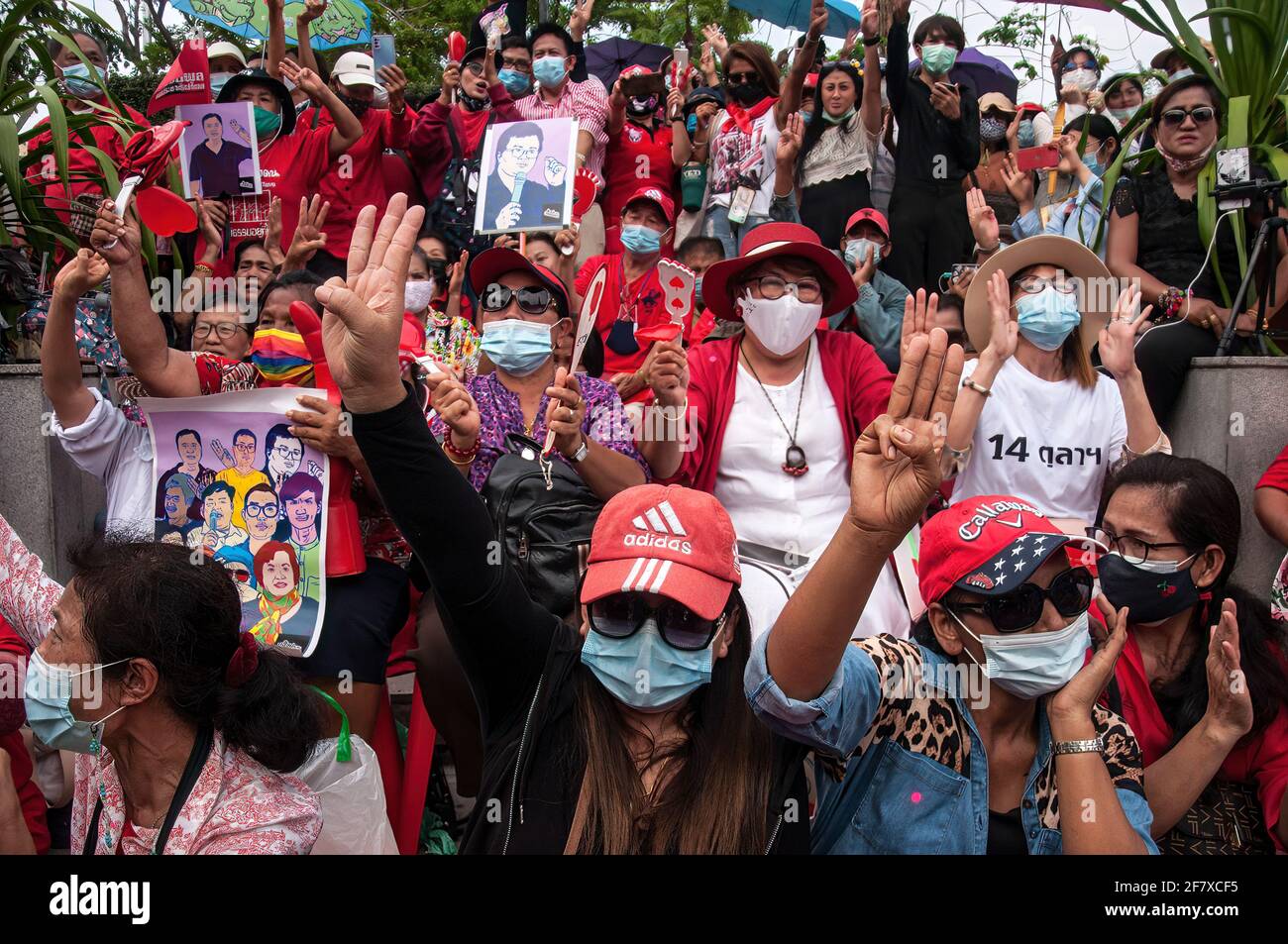 Protesters make three finger salute during the anniversary. Former core ...