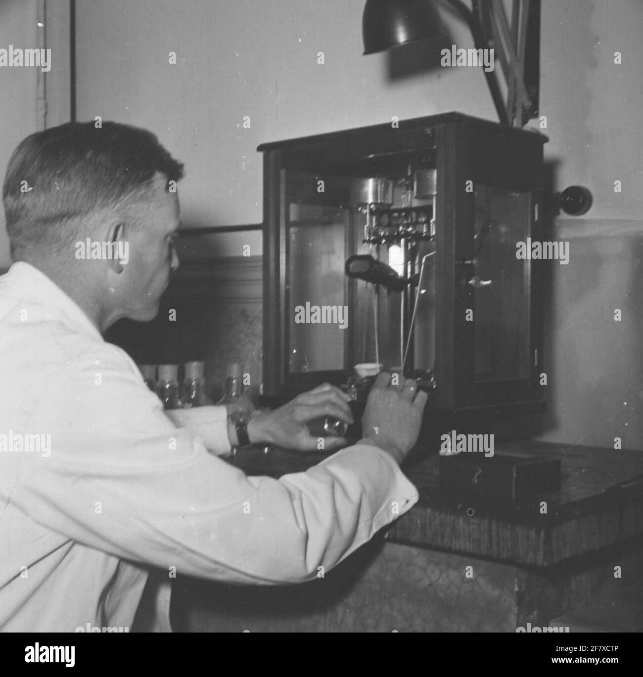 Laboratory working with an analysis balance, an extremely accurate ...