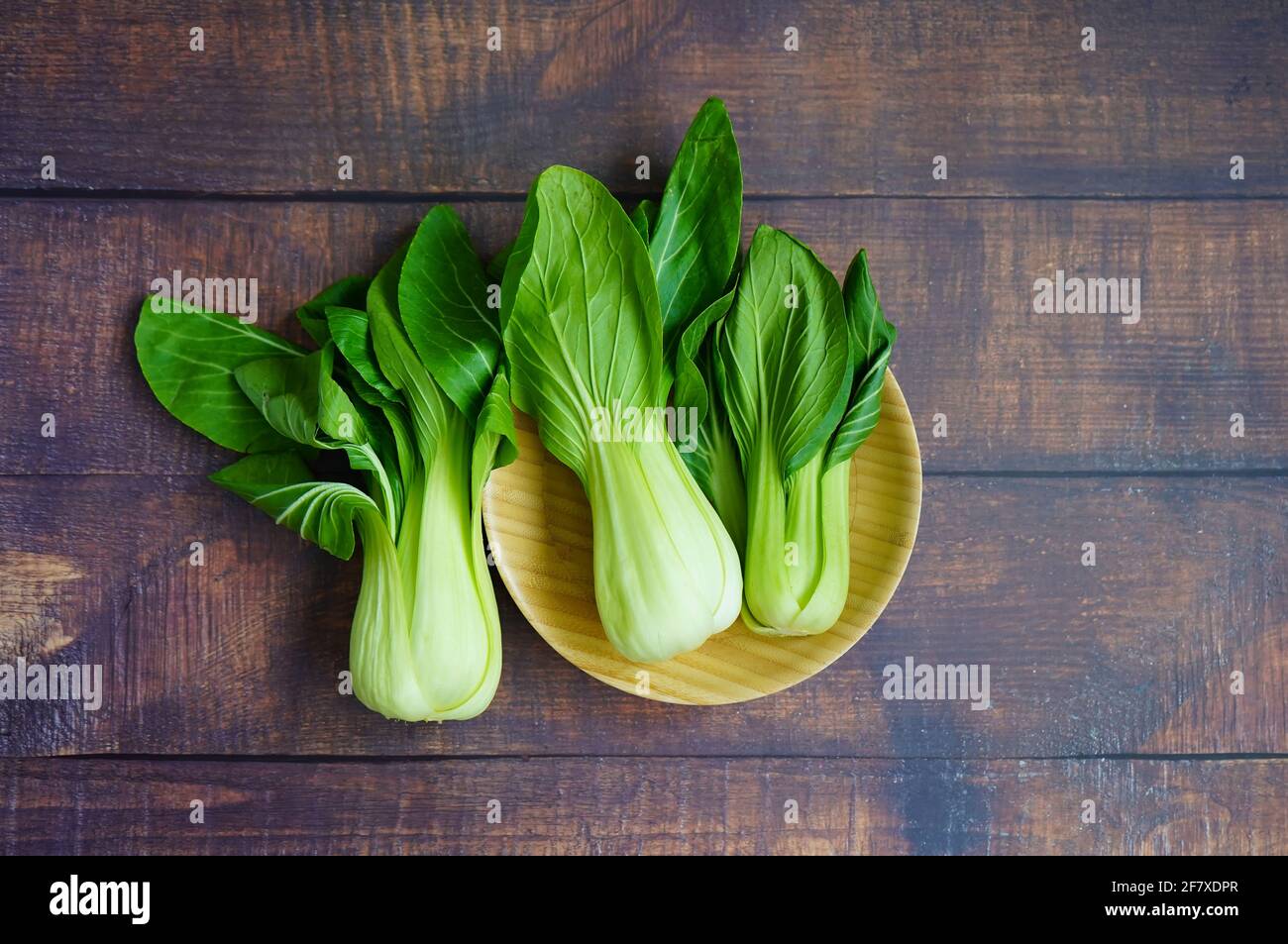 A bamboo plate with fresh Chinese "pak choi" cabbage Stock Photo - Alamy