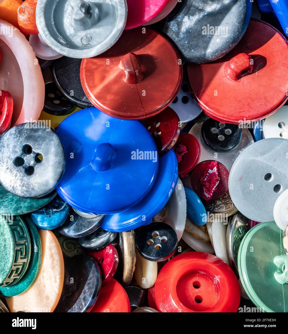 various types of buttons stored in a glass container Stock Photo - Alamy