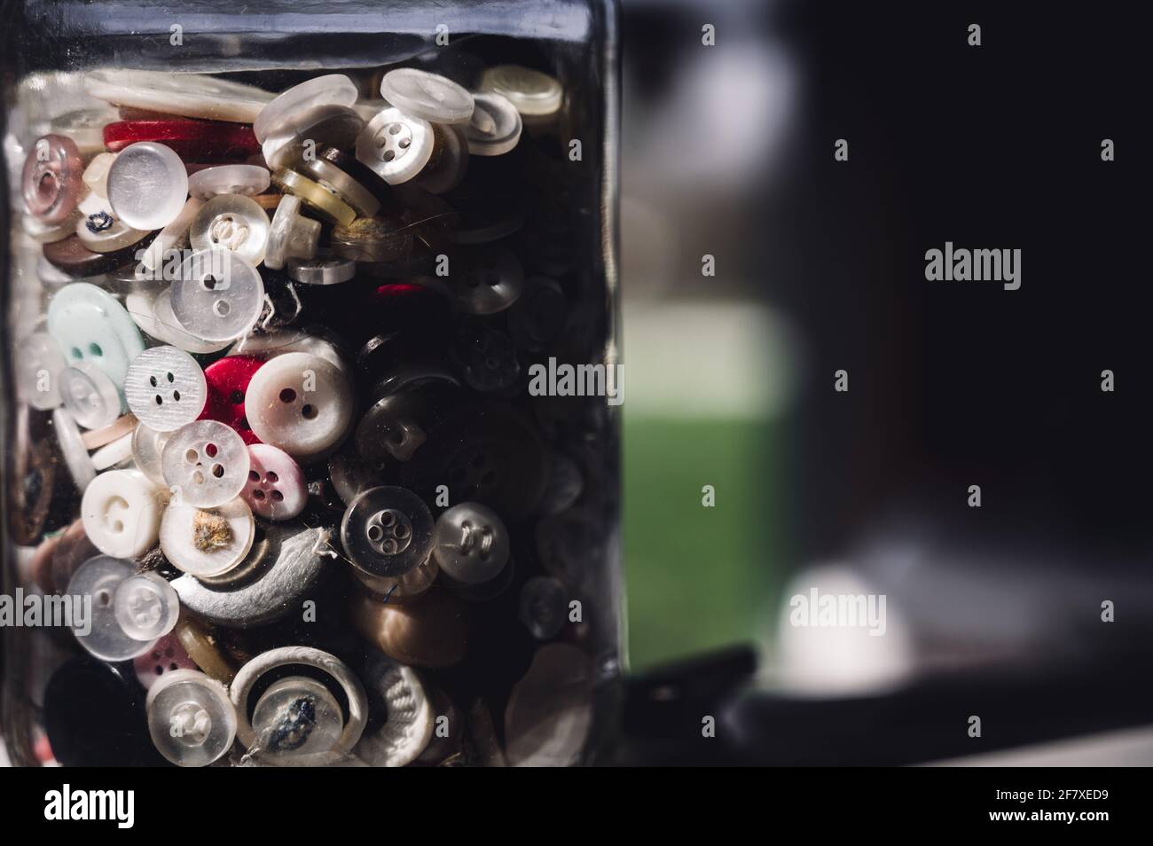 various types of buttons stored in a glass container Stock Photo - Alamy