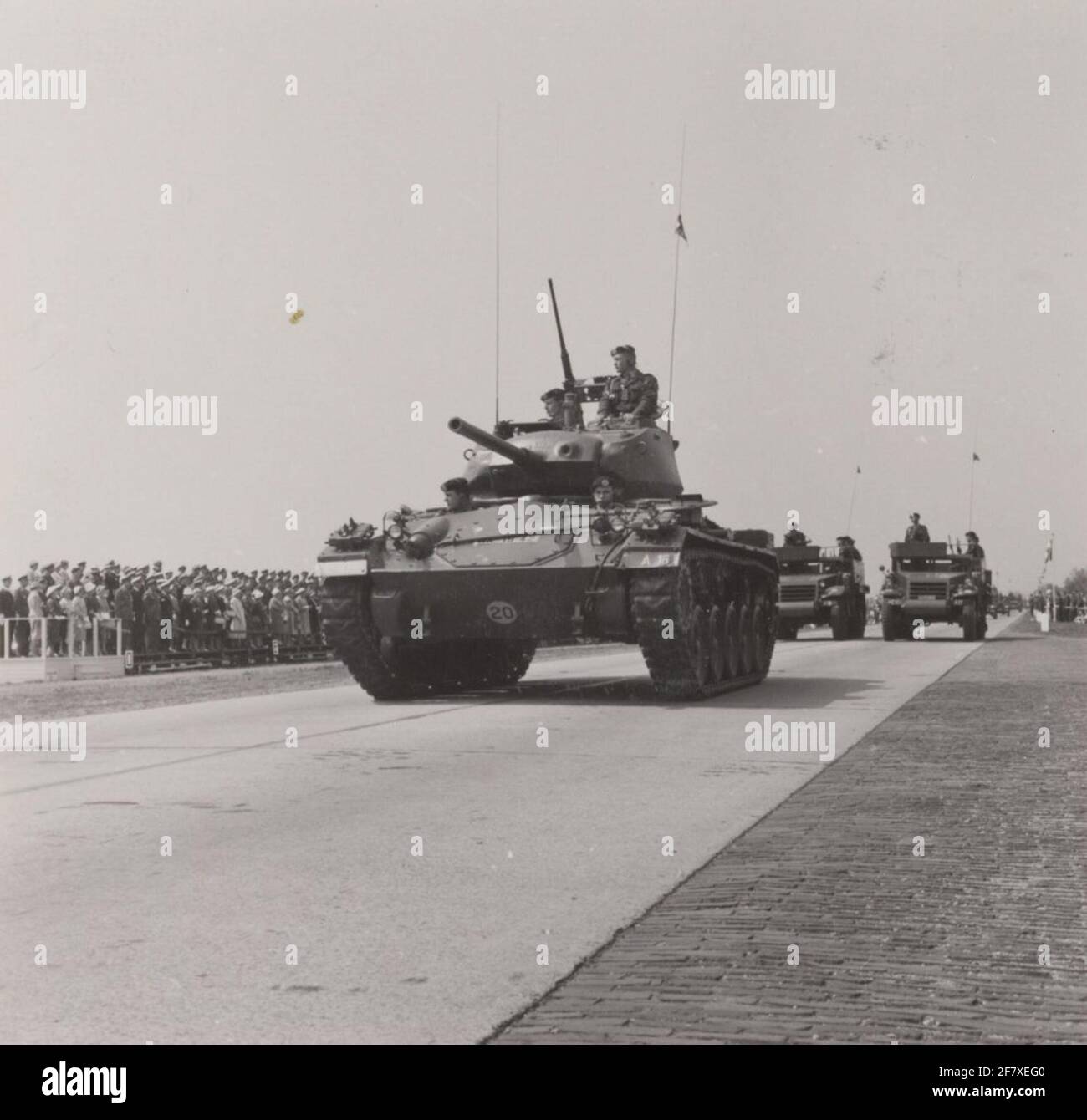 An M24 chaffee light combat tank with a M3A1 semi-truck behind during a ...