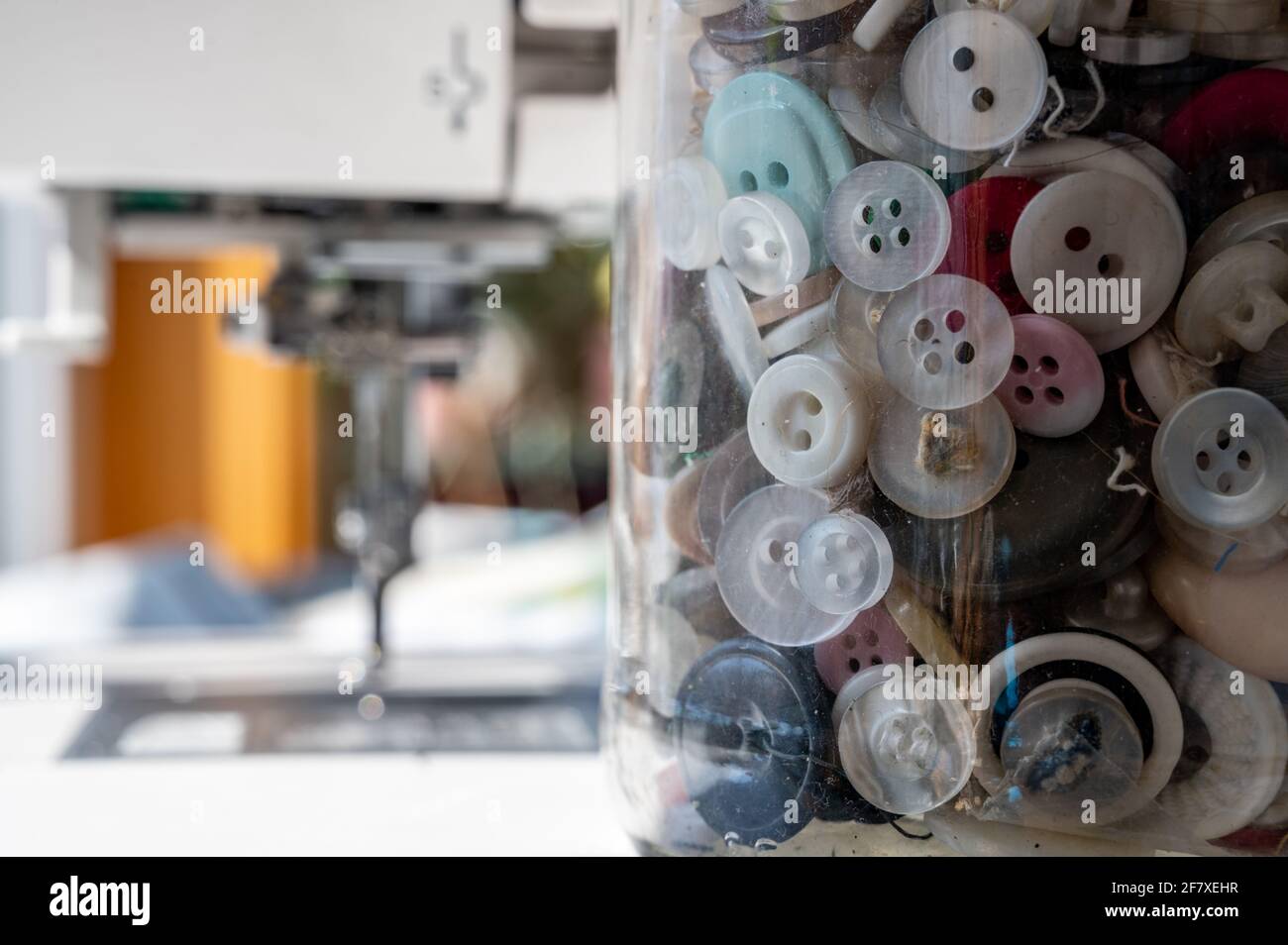 various types of buttons stored in a glass container Stock Photo - Alamy