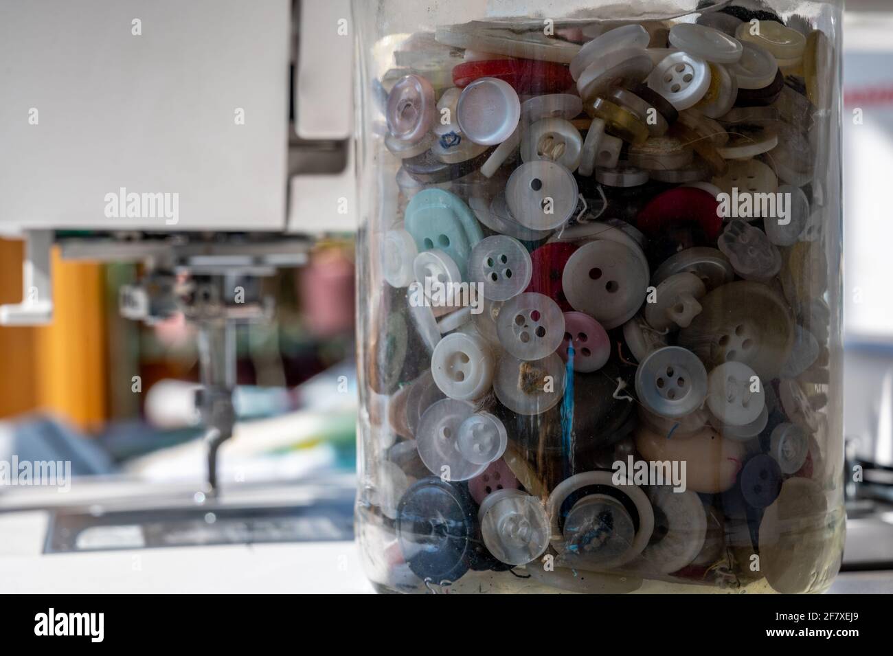 various types of buttons stored in a glass container Stock Photo - Alamy