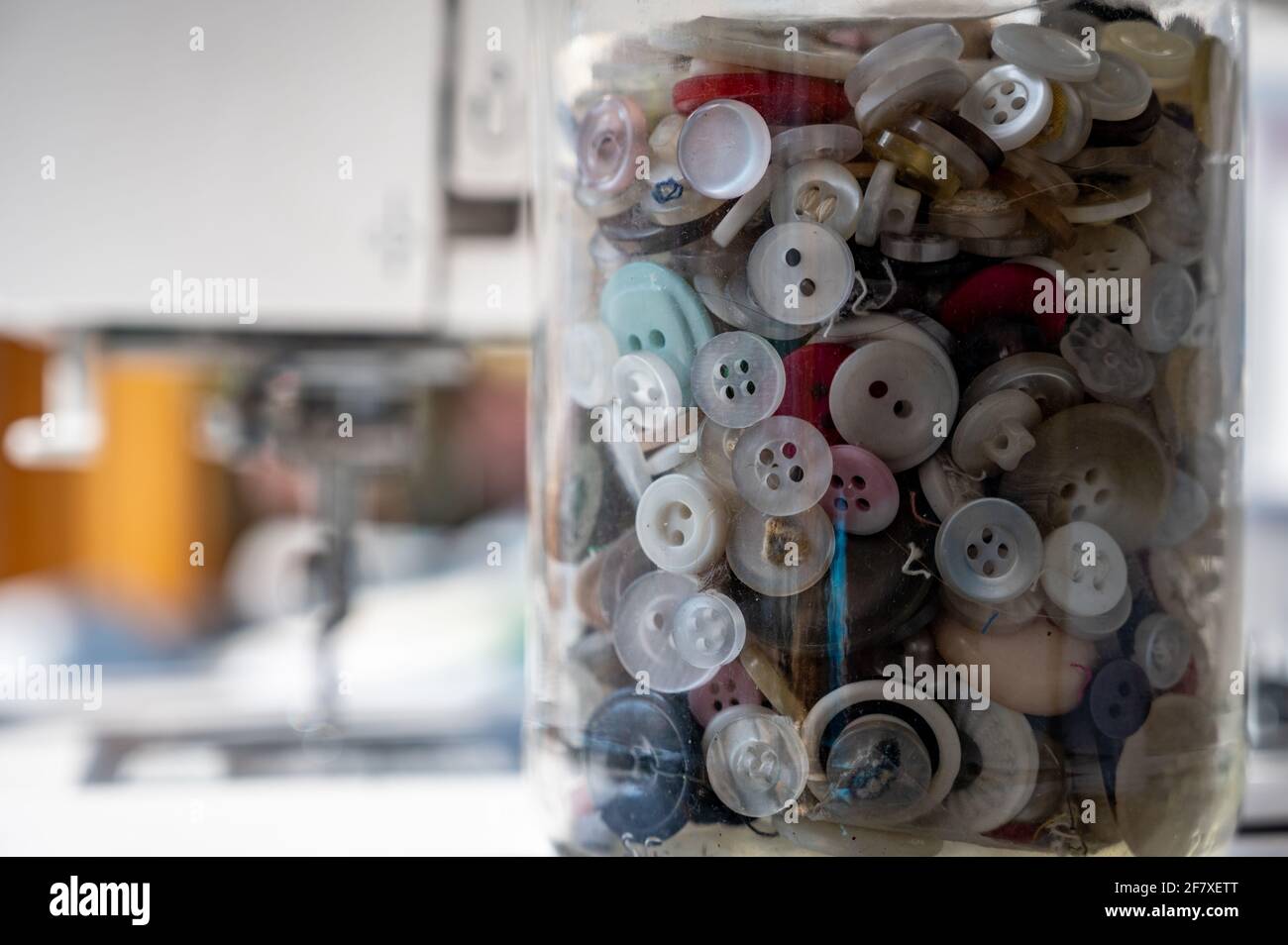various types of buttons stored in a glass container Stock Photo - Alamy