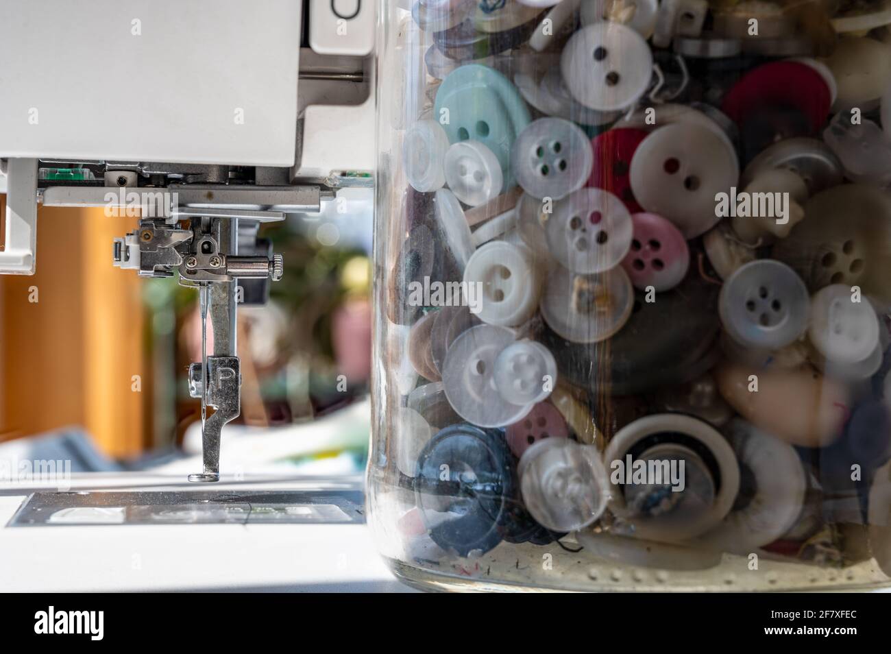 various types of buttons stored in a glass container Stock Photo - Alamy