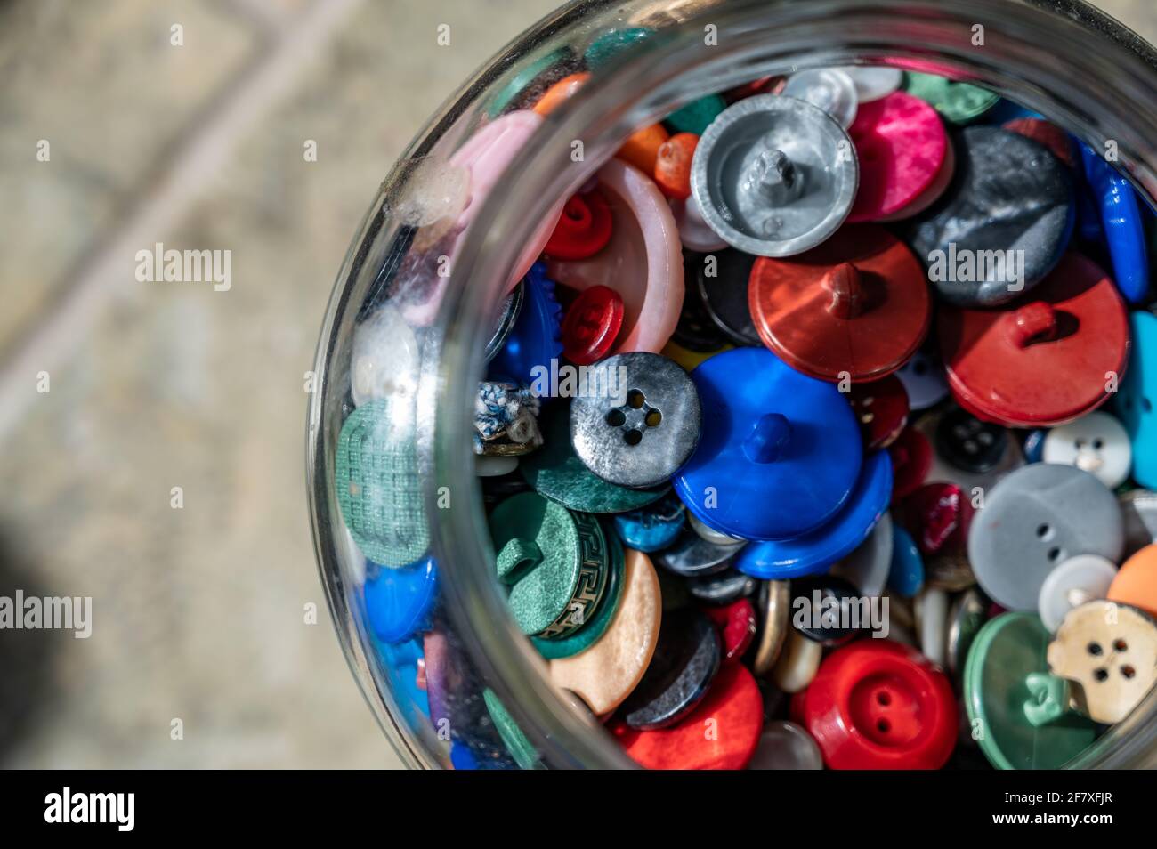 various types of buttons stored in a glass container Stock Photo - Alamy