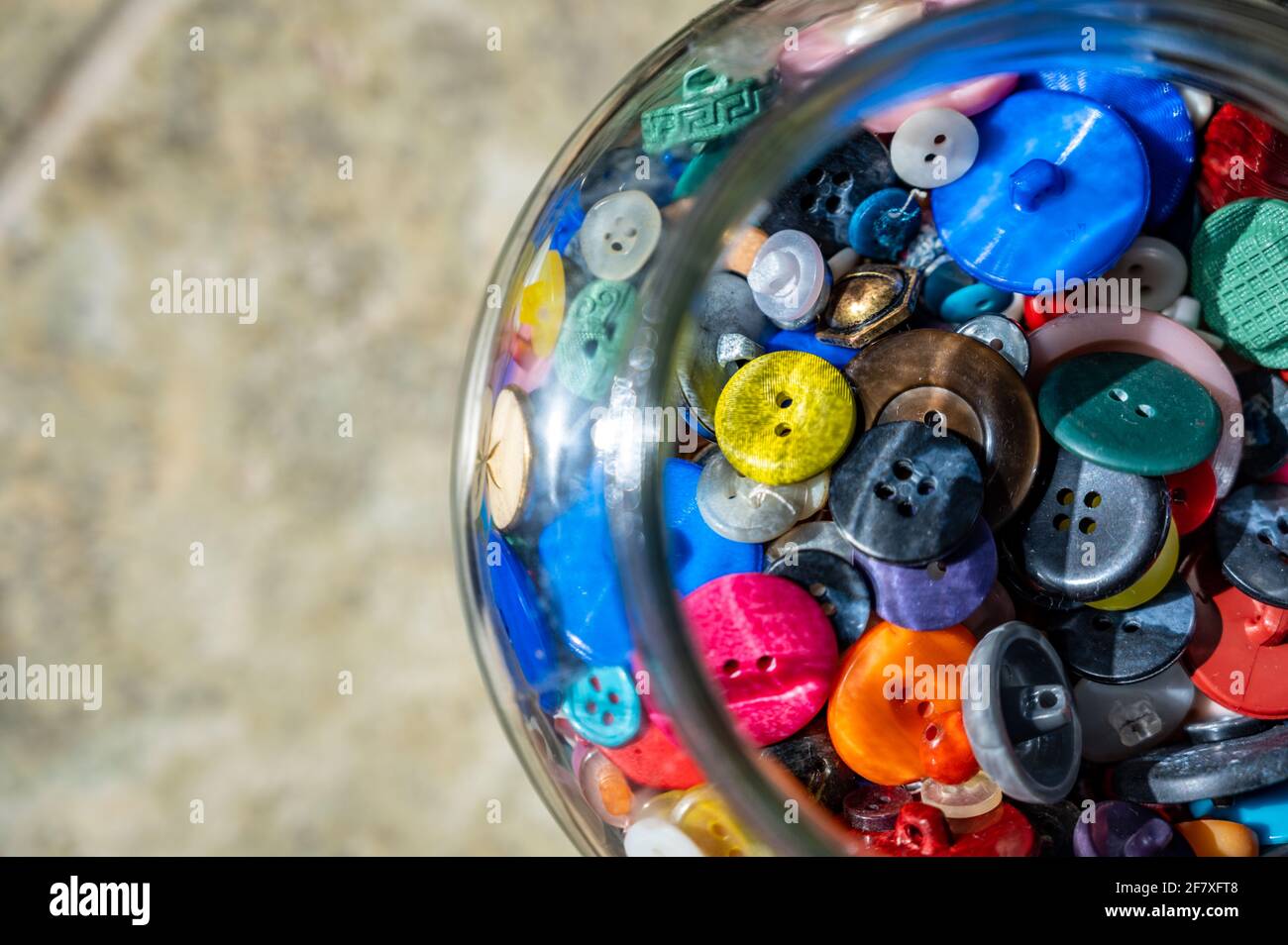 various types of buttons stored in a glass container Stock Photo - Alamy