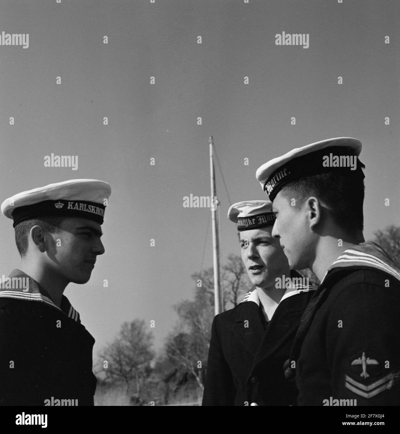Dutch sailors in conversation with a Swedish sailor during a visit from ...