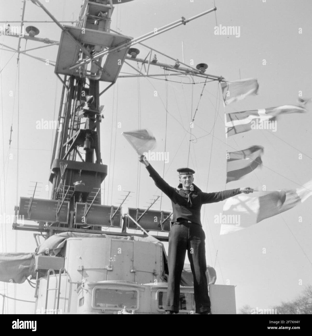 Semaphor signals with signal flags through a sailor aboard an Evertse ...