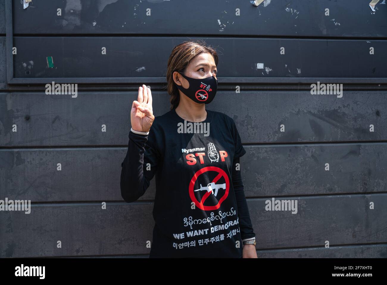 A protester makes a three-finger salute near the embassy of China ...