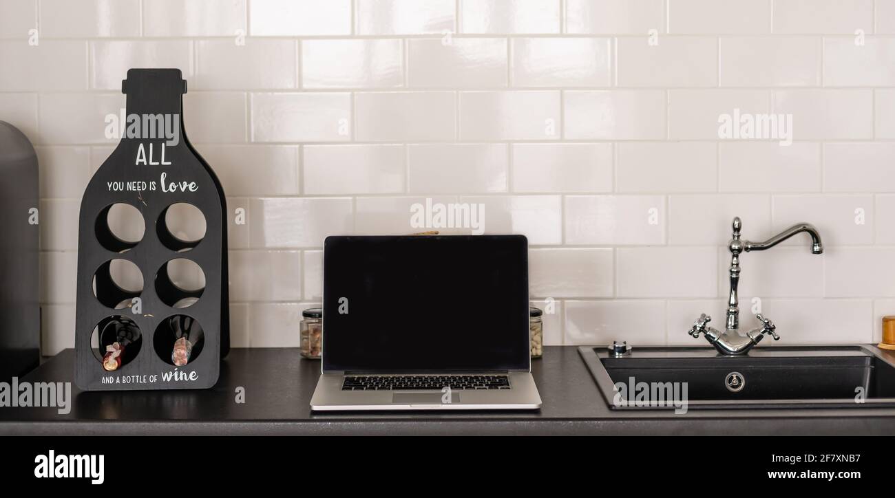 Laptop white screen on table with kitchen background Stock Photo - Alamy