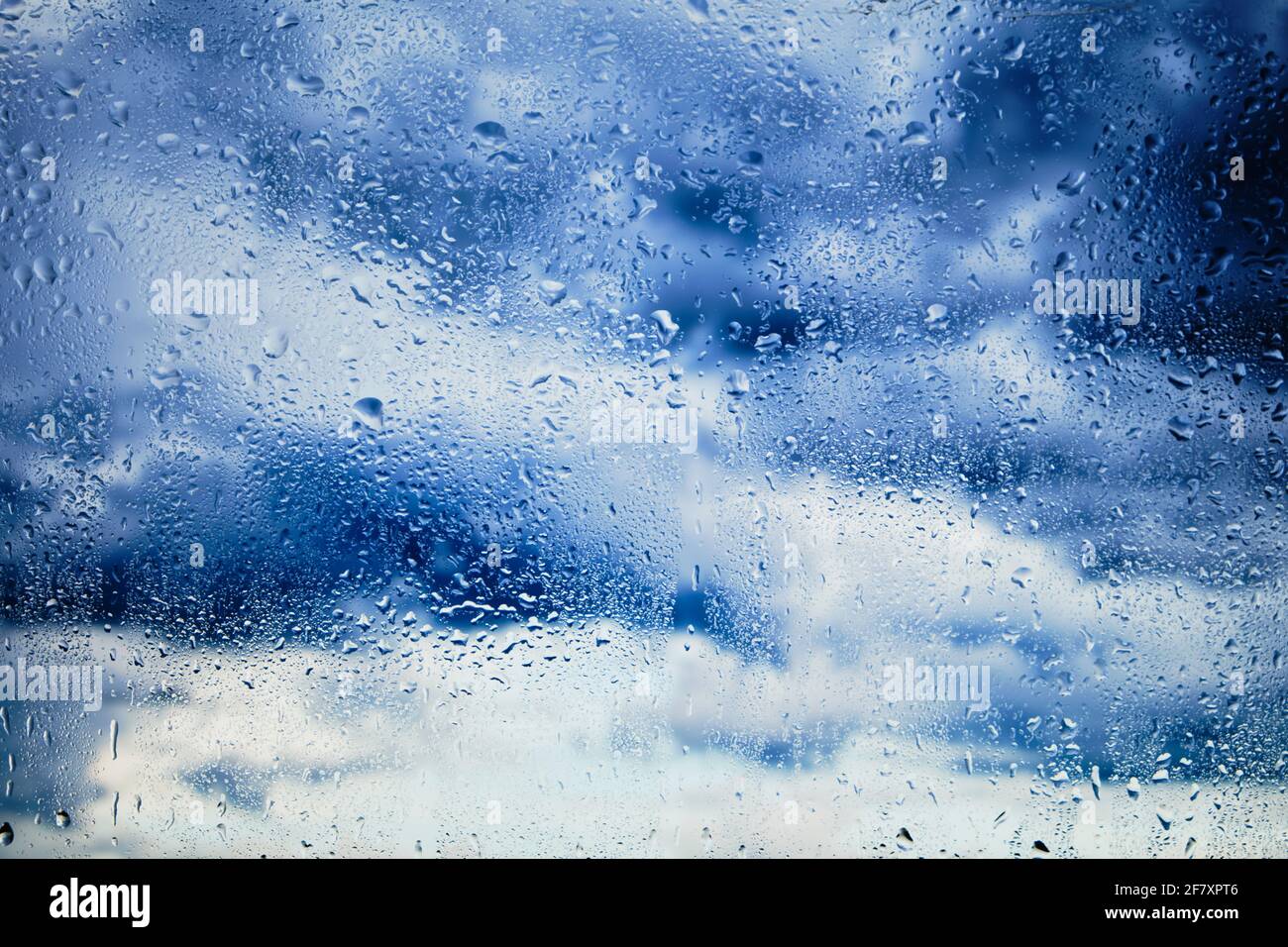 Wet, fogged glass in rain against background of clouds. Cloudy rainy ...