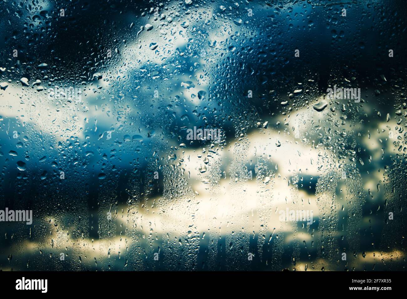 Wet, fogged glass in rain against background of clouds. Cloudy rainy ...