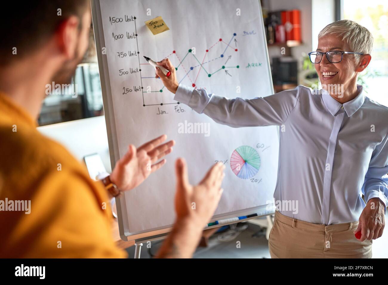 Business colleagues in a working atmosphere at workplace talking about ...