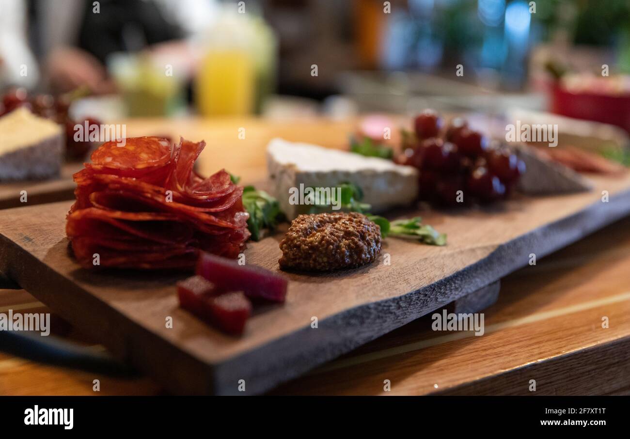 Cheese and meat board on a table at a party with self service Stock ...