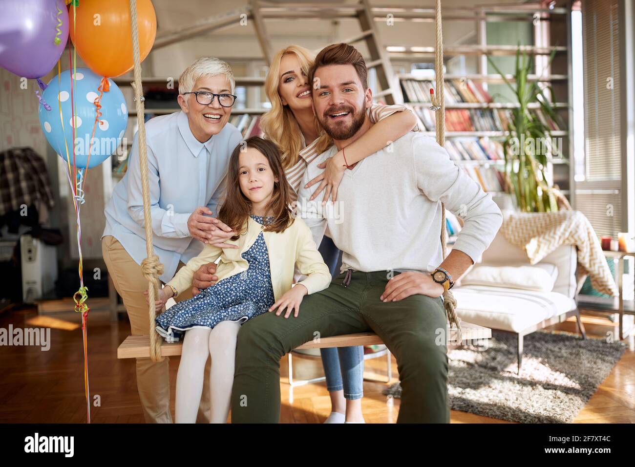 Happy family portrait with grandmother at home; Happy family offspring ...