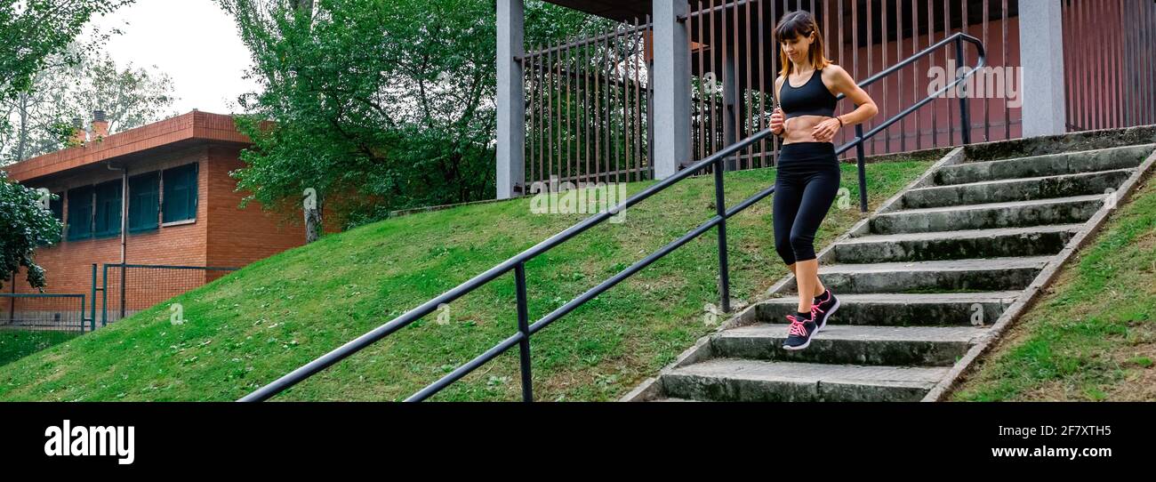Female athlete going down stairs outdoors Stock Photo - Alamy