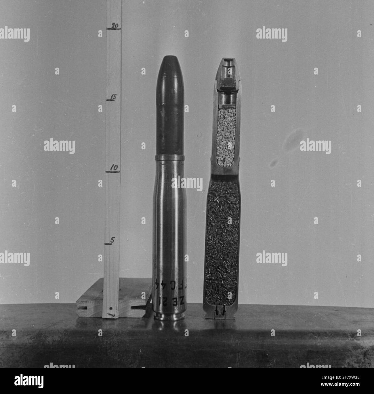 A complete 20 mm grenade with a cross-sectional view of the pushing and ...