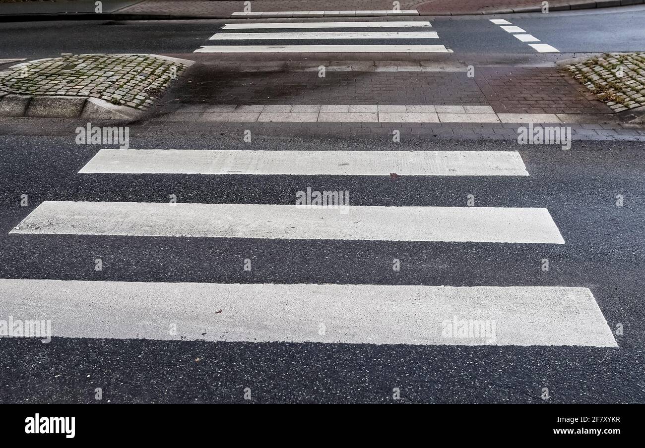 White painted pedestrian zebra crossing on a road in Europe Stock Photo ...