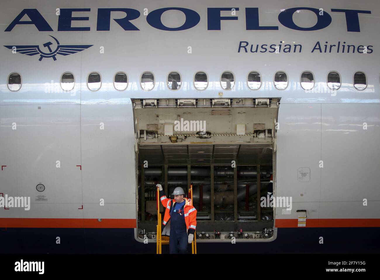 An employee inspects the cargo hold of a Boeing-777 aircraft, during ...