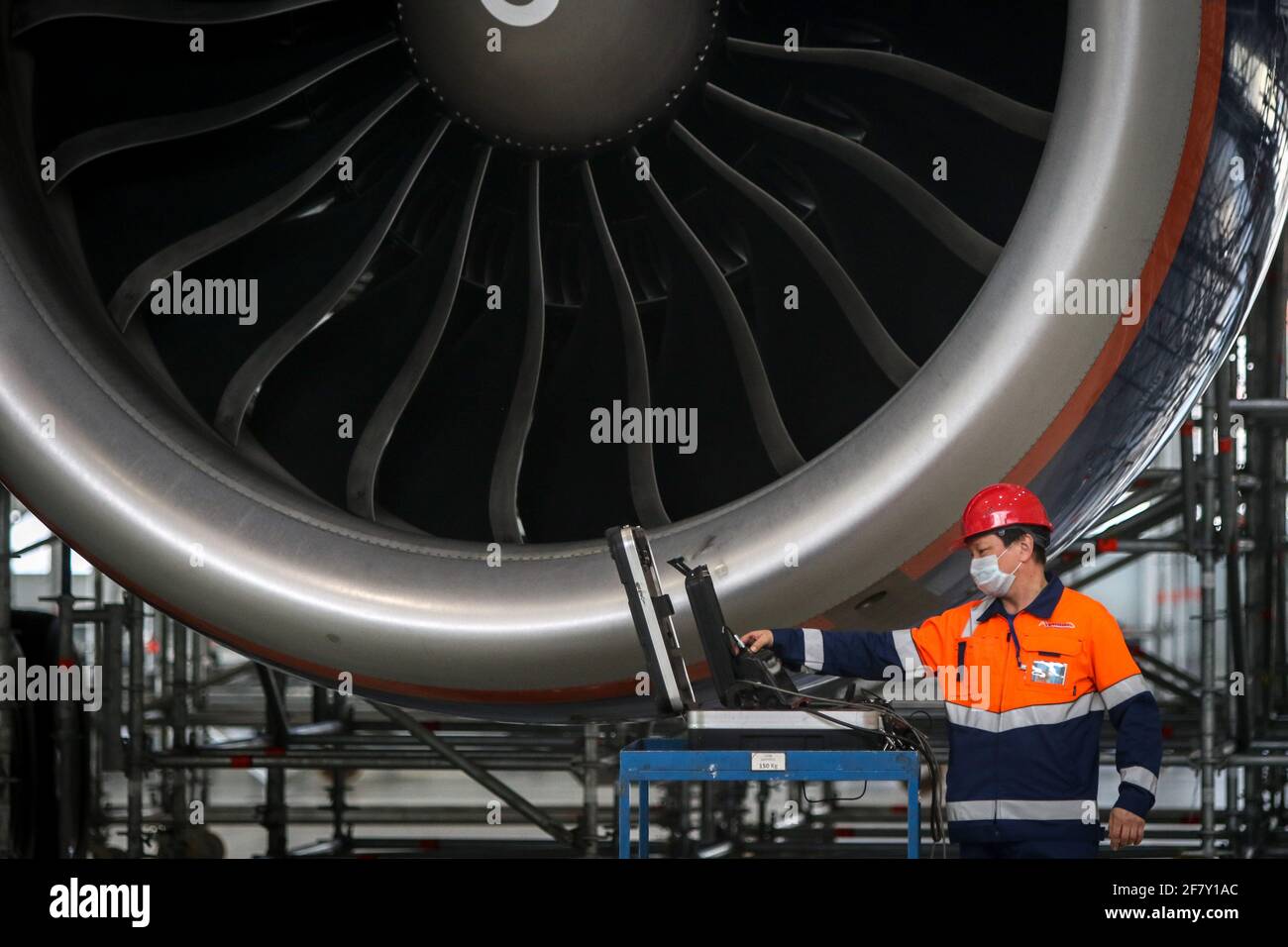An employee inspects the engine of a Boeing-777 aircraft, during the ...