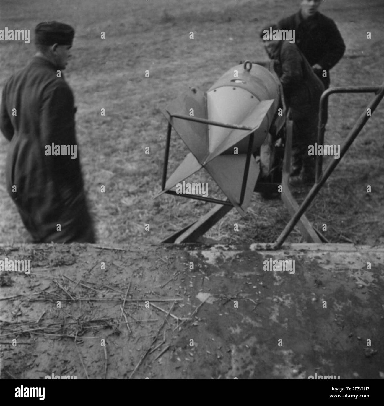 Luftwaffe staff charges bombs on a special lifting trolley at Airport ...