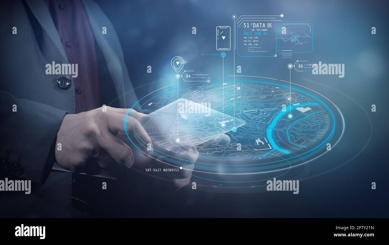 A man works with a virtual map through a tablet Stock Photo - Alamy