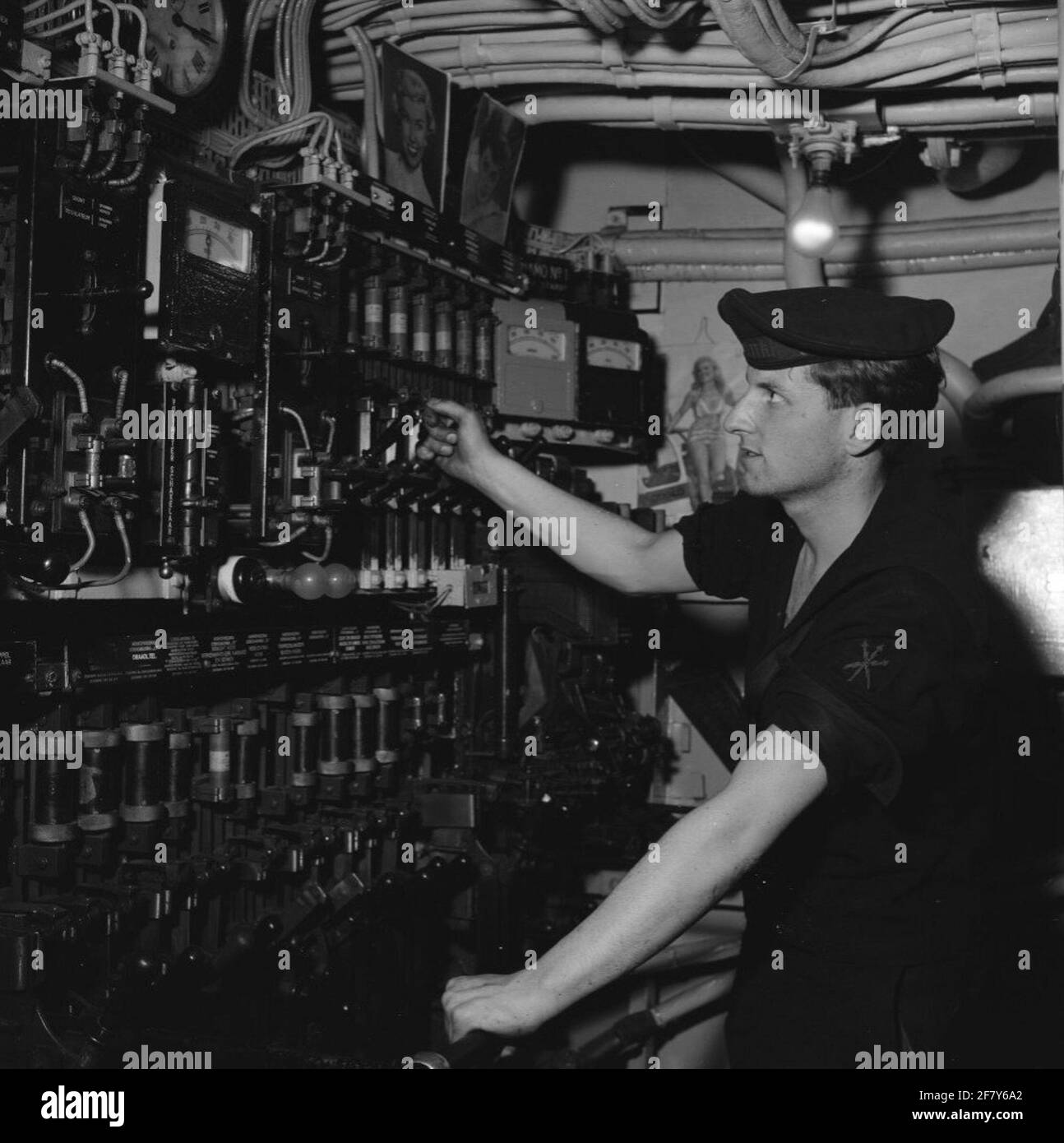 An electrician of the torpedo boat hunter Hr.Ms. Evertsen (D 802) at a ...