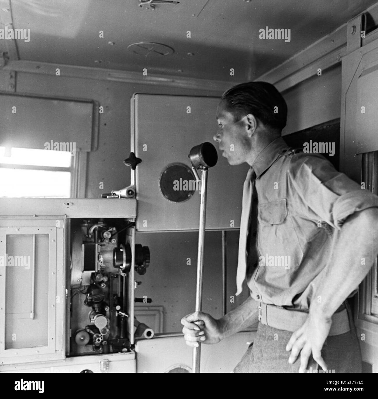 Military staff in communication vehicle with microphone, and left a ...