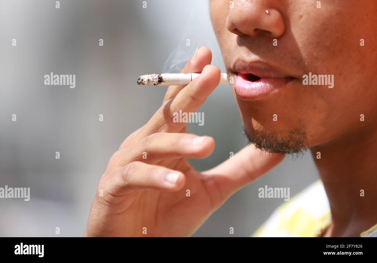 Smoking a cigarrette hi-res stock photography and images - Alamy