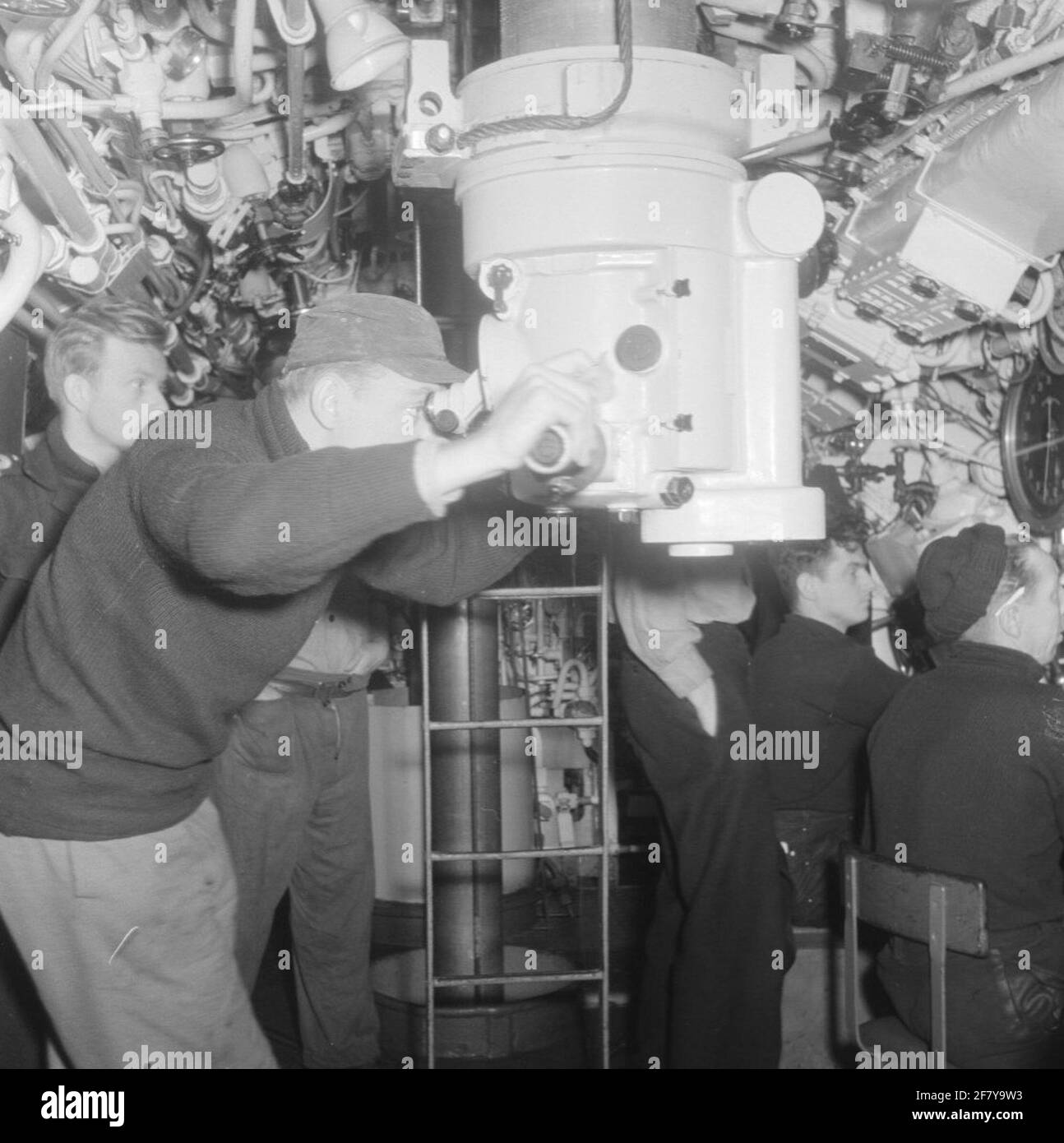 Commander of a submarine looks through the periscope Stock Photo - Alamy