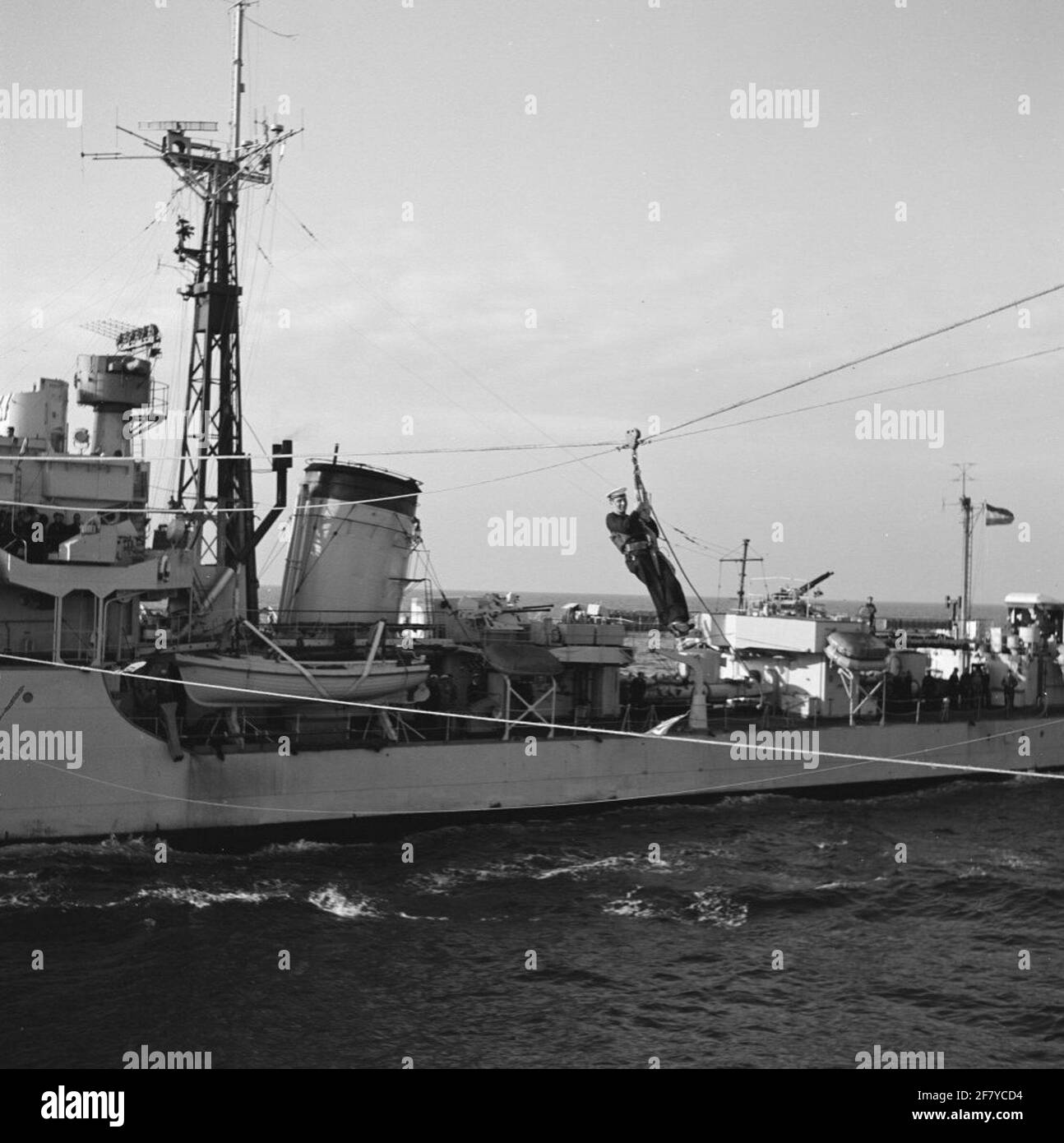 Transfering a sailor in the high seas, 1956. On the background a ...