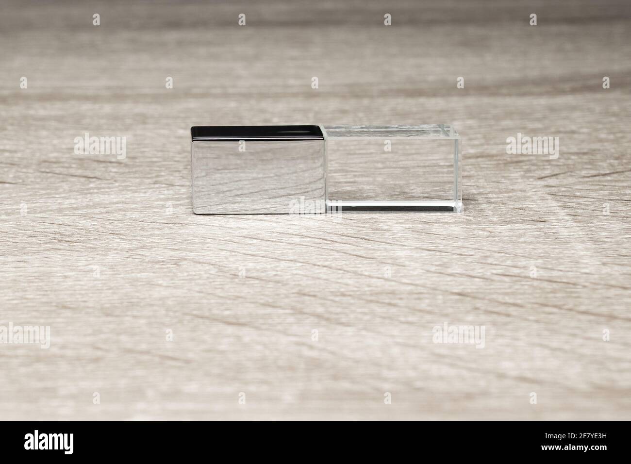 Closed metal USB flash drive on woodern isolated background. Copy space ...