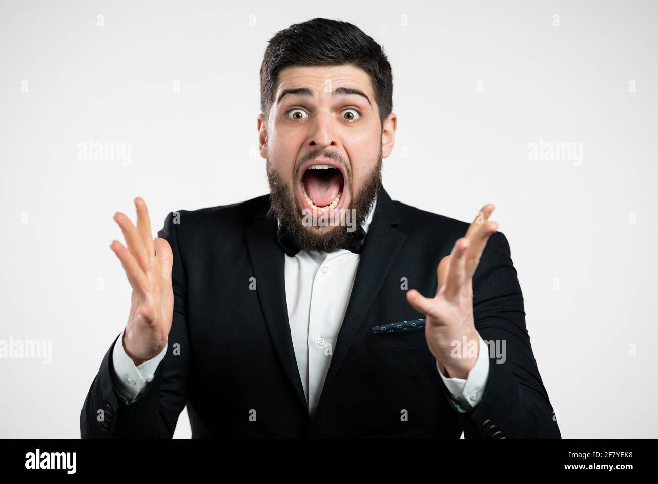 Man in tuxedo depicts amazement, showing WOW delight face effect ...
