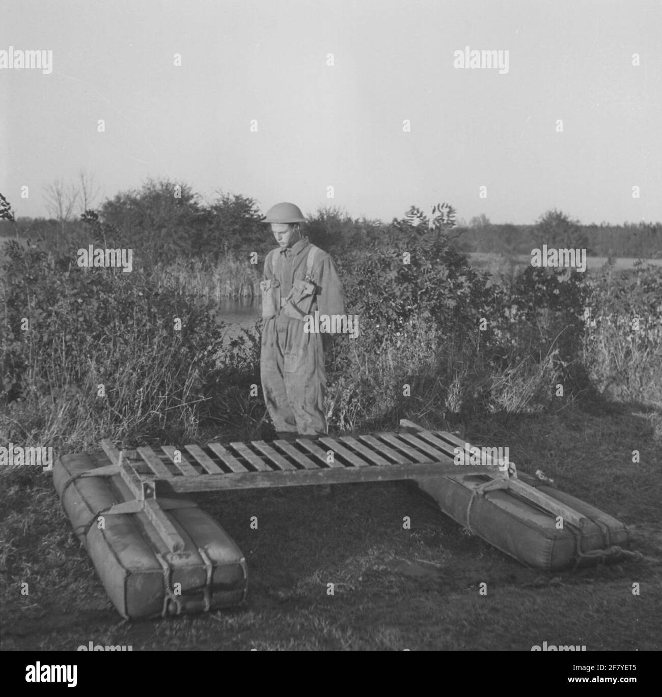 In addition to a part of a floating walkway, a soldier stands for ...