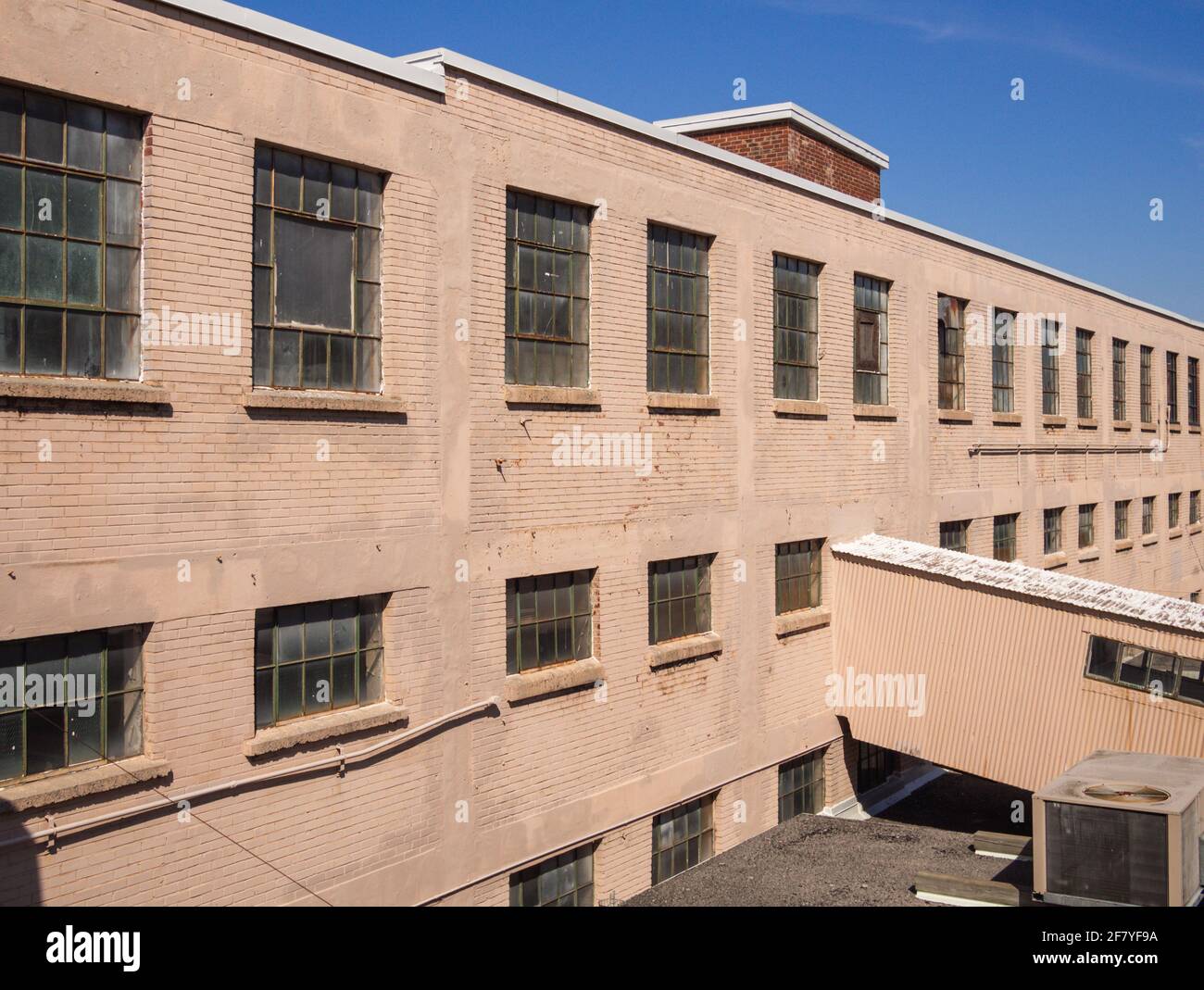 pink brick wall building in an industrial area Stock Photo - Alamy