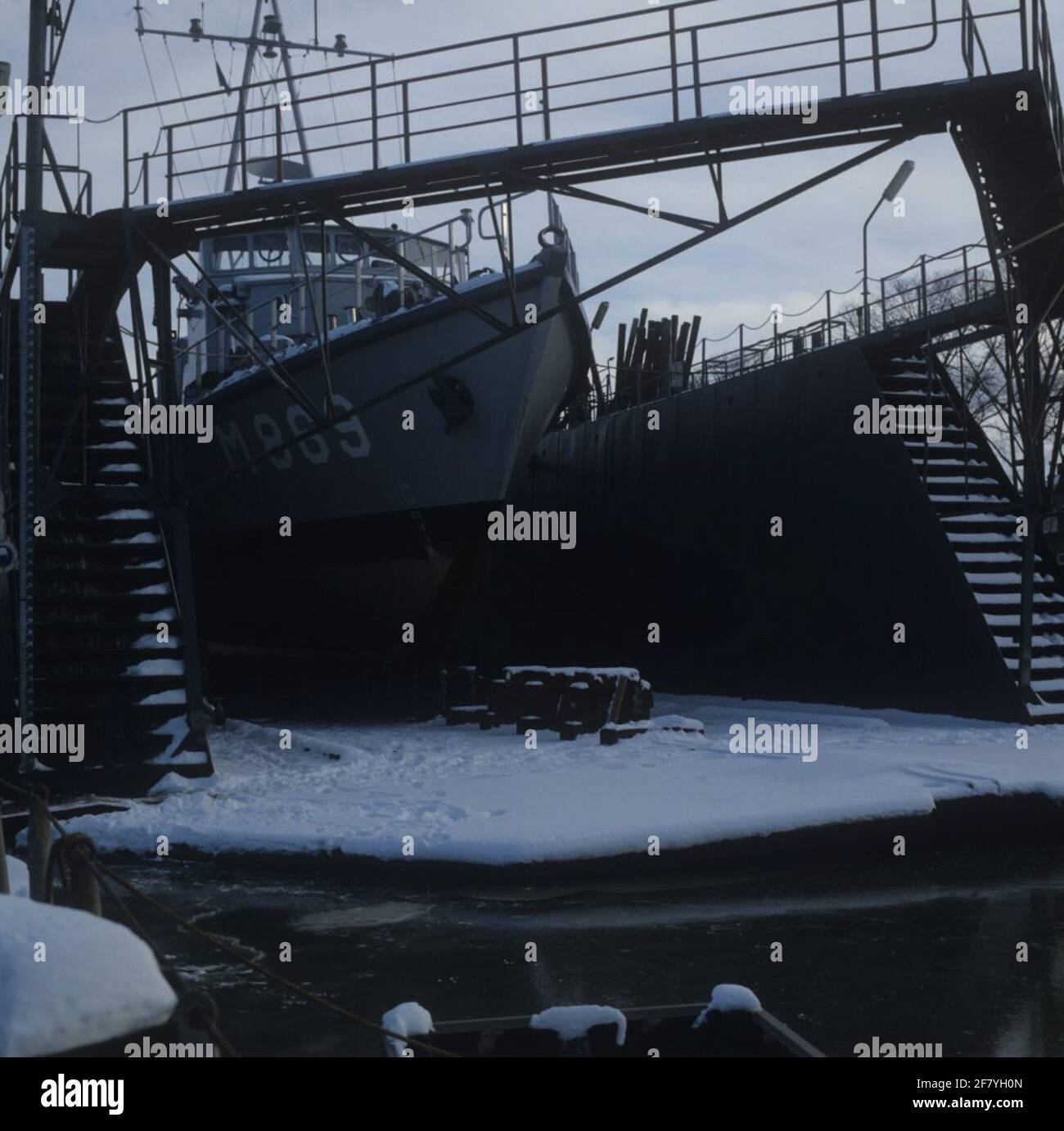 The shallow water mine sweep Hr.Ms. Bussemaker (M 869) in a snowy dock ...