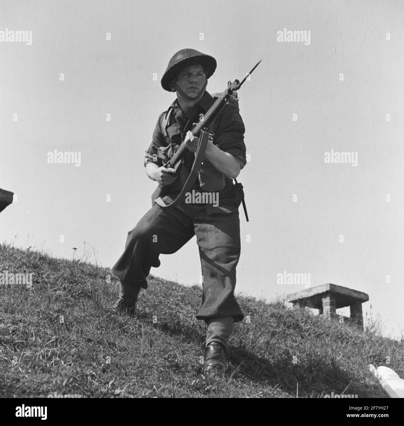 An infantryman with combat packaging and his Lee Enfield rifle with ...