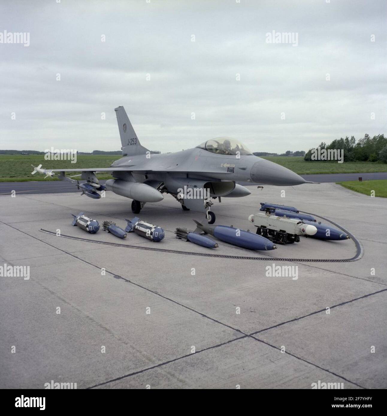 An F-16A with various types of bombs in the foreground. From left to right:. BL 755 cluster bomb ...