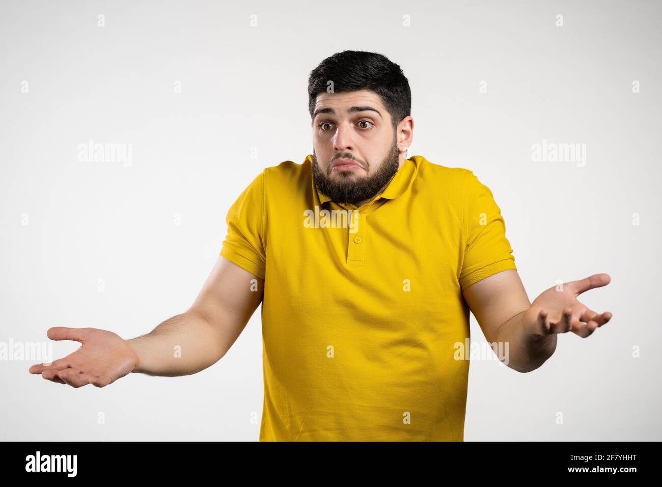 Indifferent unsure man makes gesture of I dont know, cant help anything ...