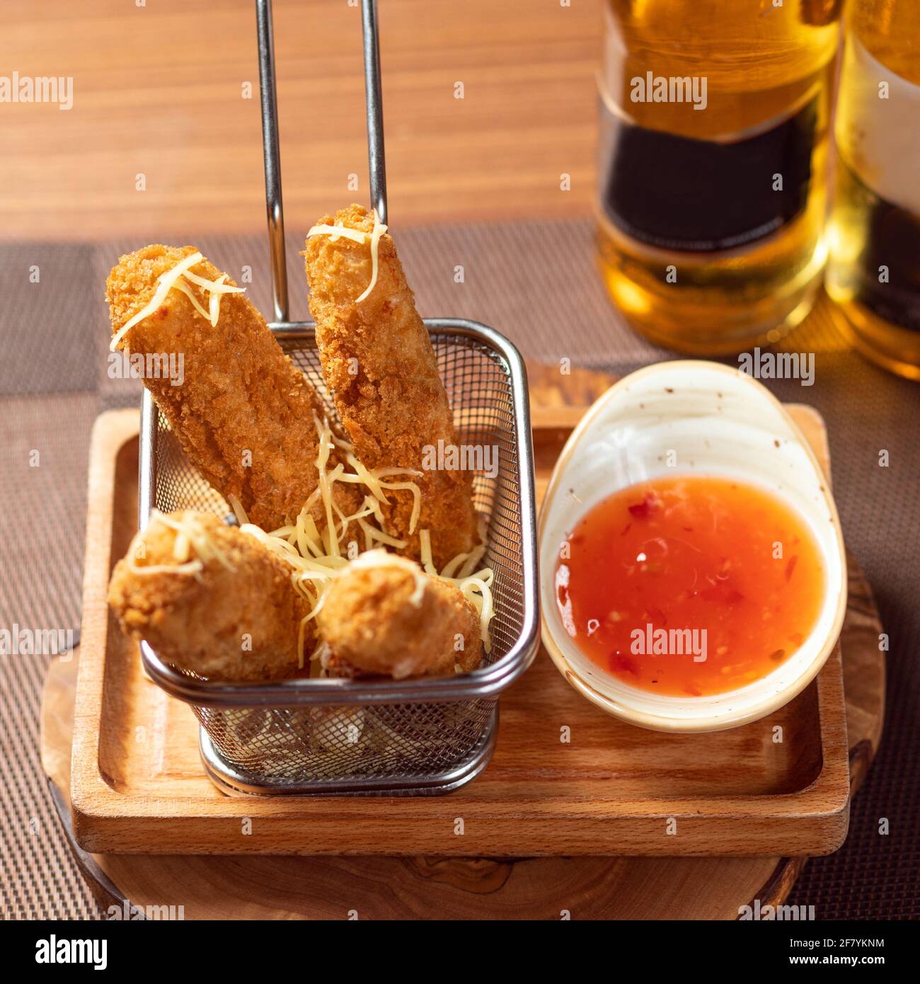 Fried breaded chicken sticks with tomato sauce with beer bottle Stock ...