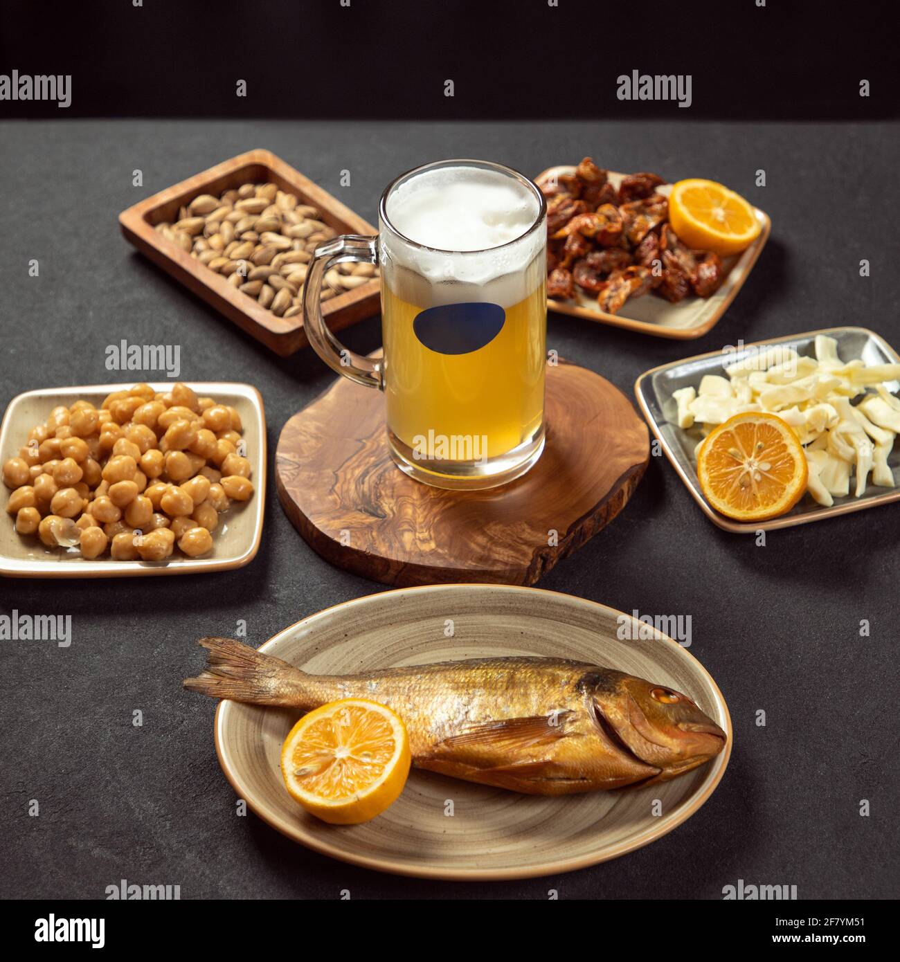 Beer mug with grilled fish, pea, cheese snacks Stock Photo - Alamy