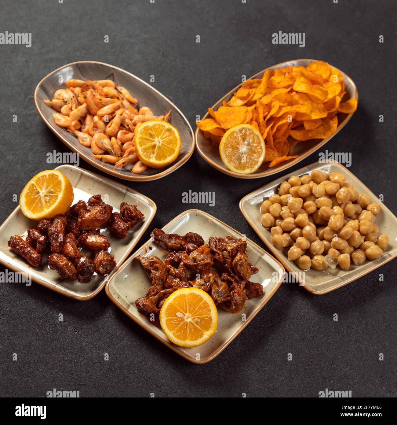 Beer snacks, grilled fish, pea, cheese, chips, chicken Stock Photo - Alamy