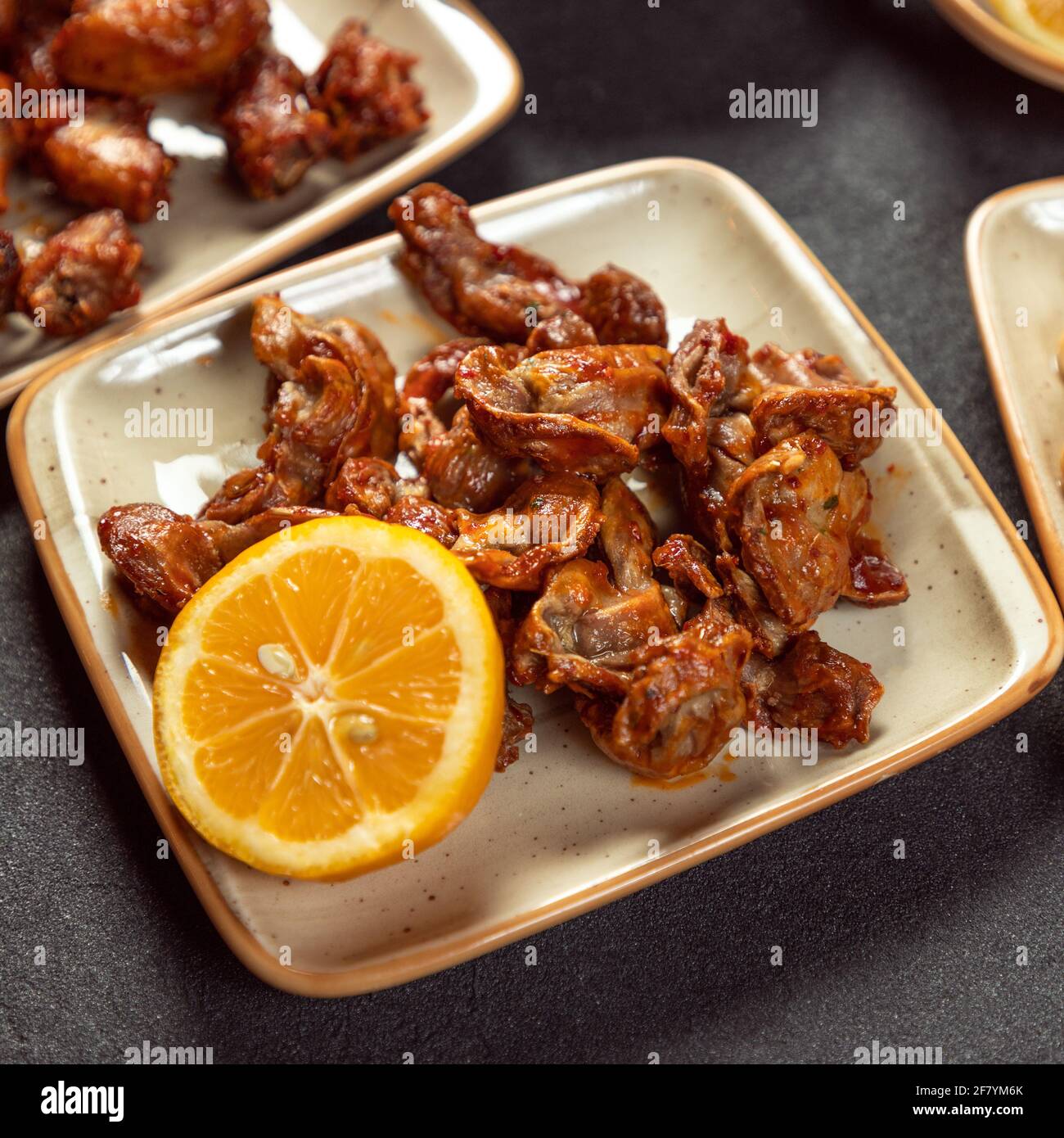 Grilled chicken dish with lemon close up Stock Photo - Alamy