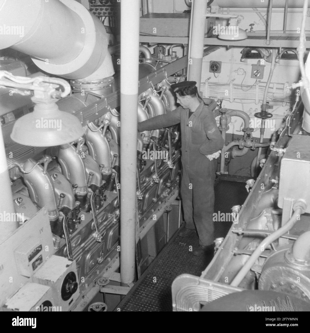 Machinist of the 1st class at diesel engine in engine room Stock Photo ...